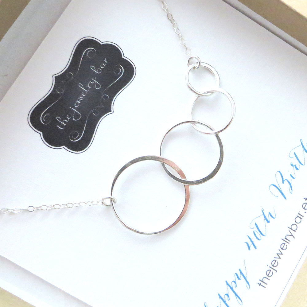 4 rings for 4 decades necklace